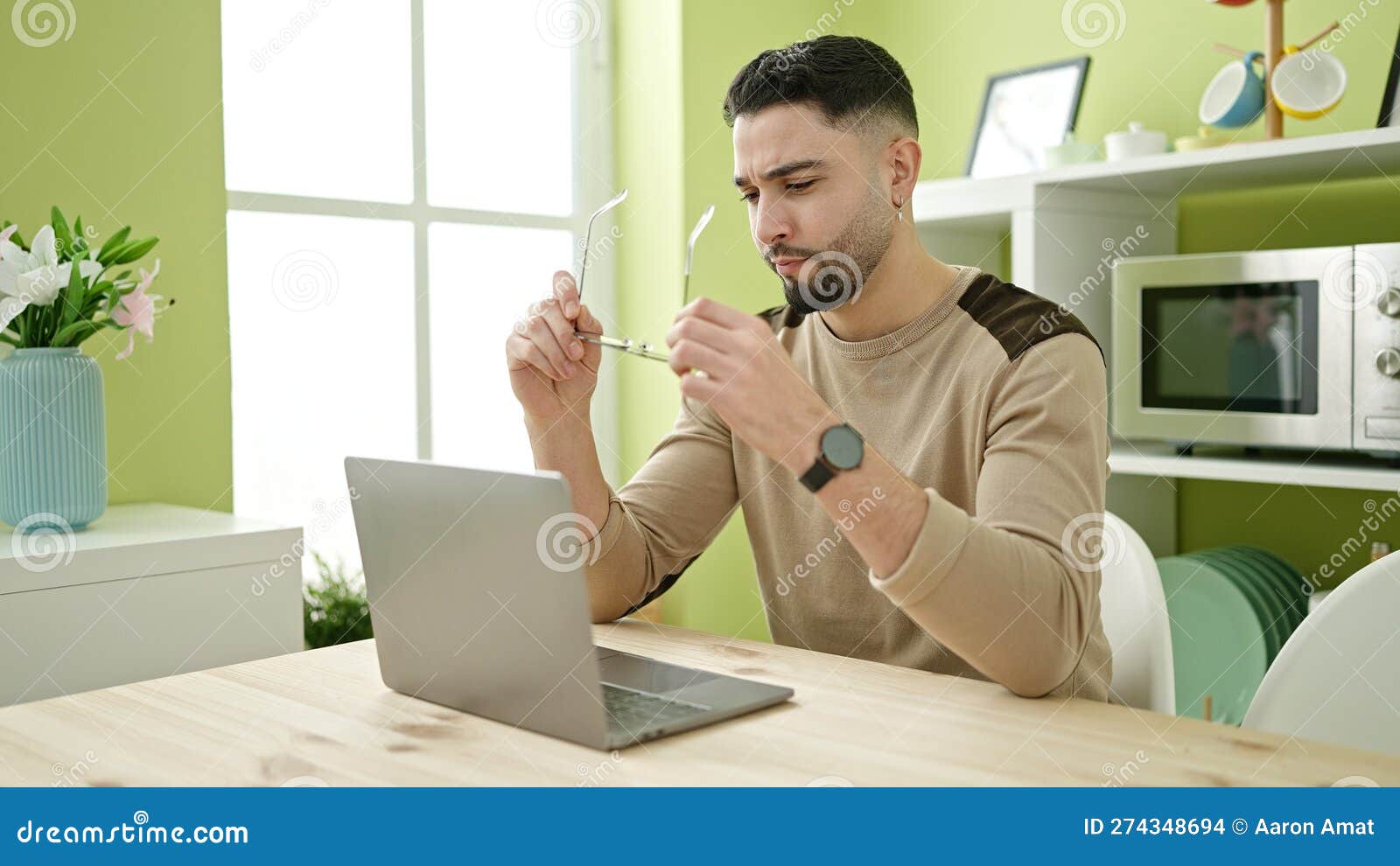 Young Arab Man Using Laptop Sitting on Table at Home Stock Photo ...