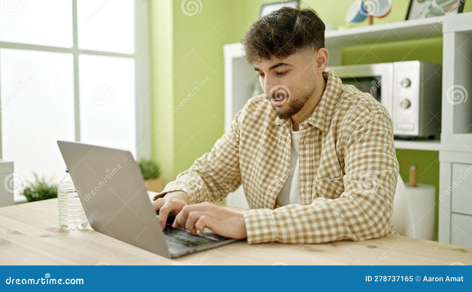 Young Arab Man Using Laptop Sitting on Table at Home Stock Image ...