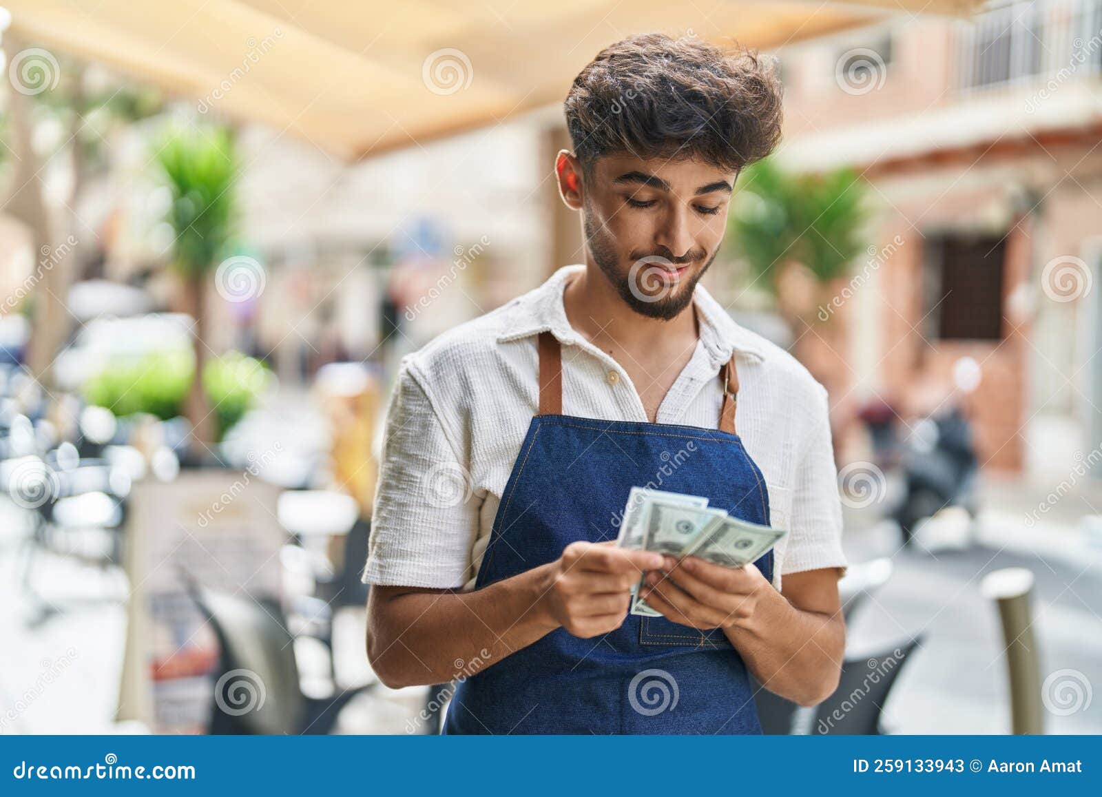Young Arab Man Waiter Counting Dollars Working at Restaurant Stock ...