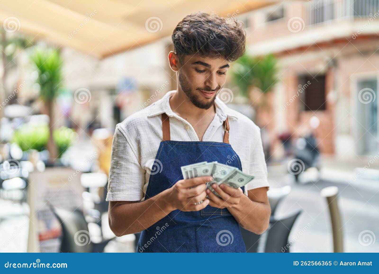 Young Arab Man Waiter Counting Dollars Working at Restaurant Stock ...