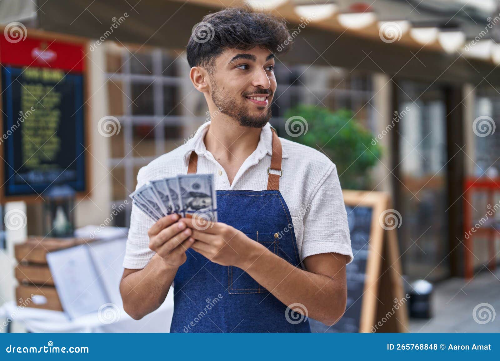 Young Arab Man Waiter Counting Dollars Working at Restaurant Stock ...