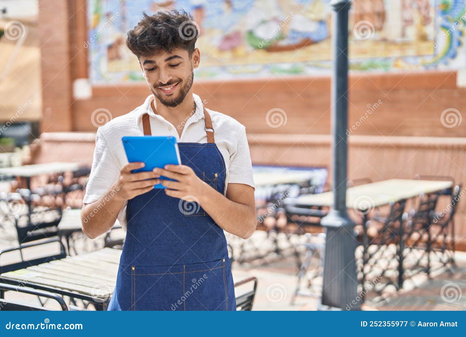 Young Arab Man Waiter Using Touchpad Working at Restaurant Stock Image ...