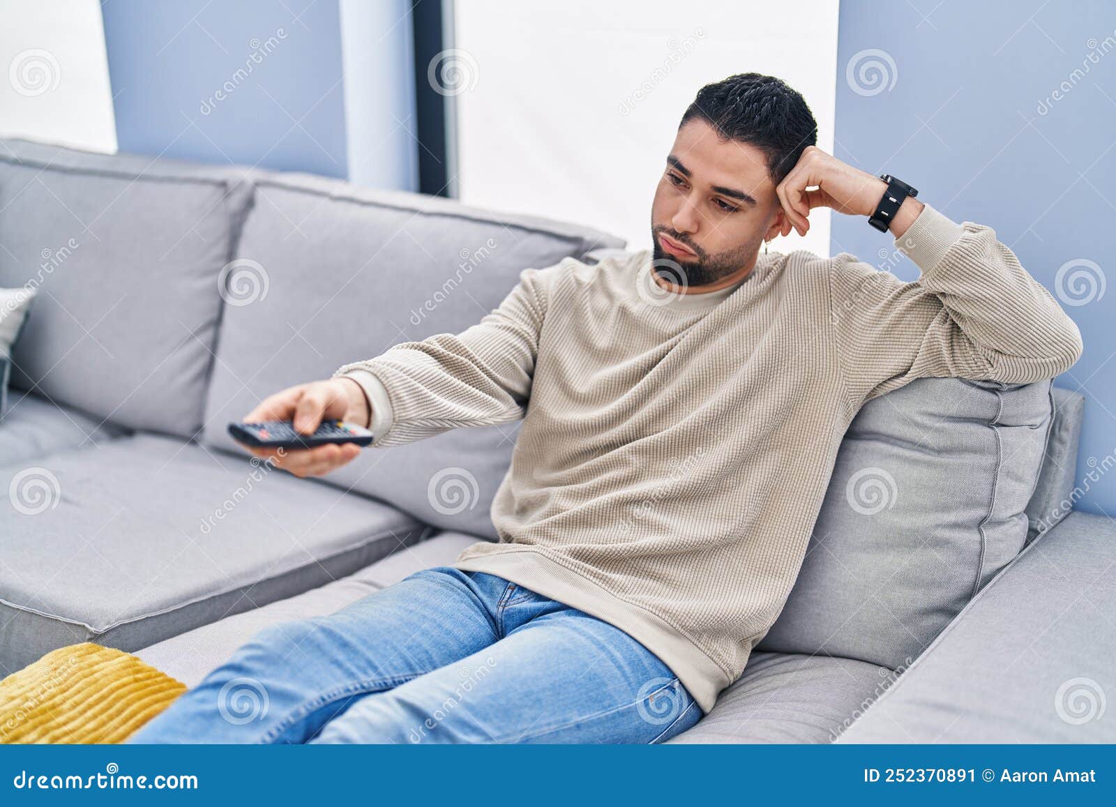 Young Arab Man Watching Tv with Boring Expression at Home Stock Image ...
