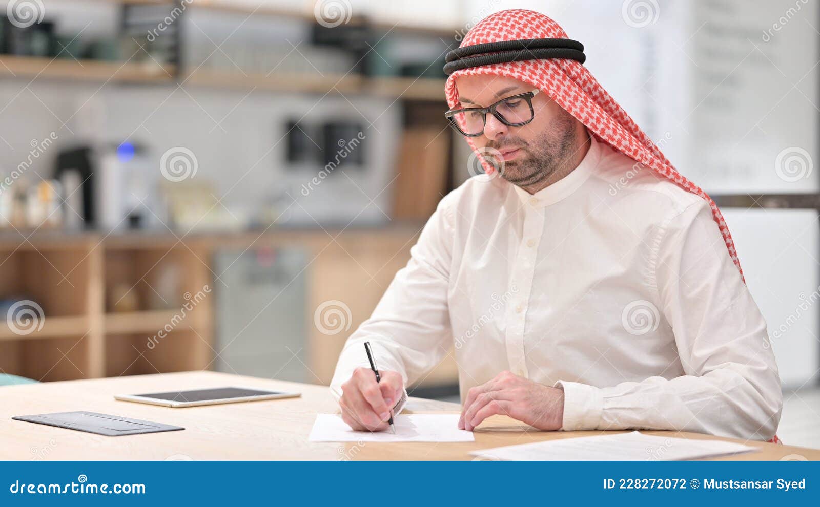 Young Arab Man Writing on Paper Stock Photo - Image of signature, paper ...