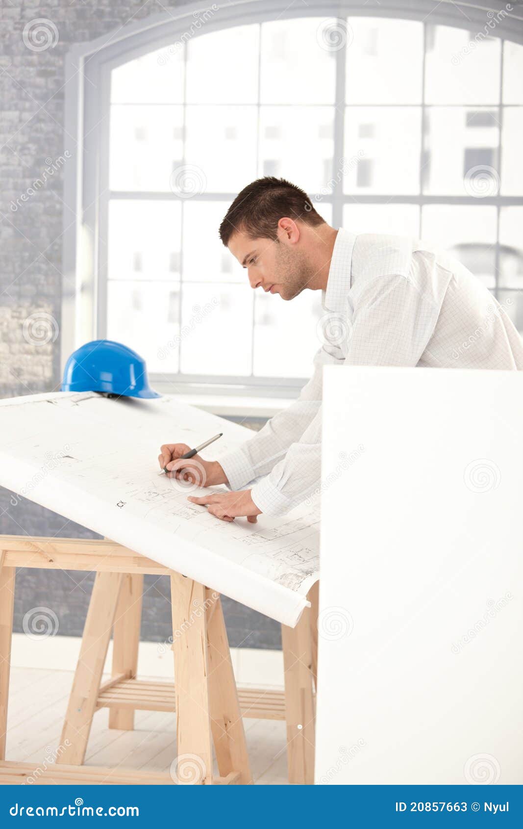 Architect Drawing Blueprints, At Desk In Office, With Pencil Stock ...