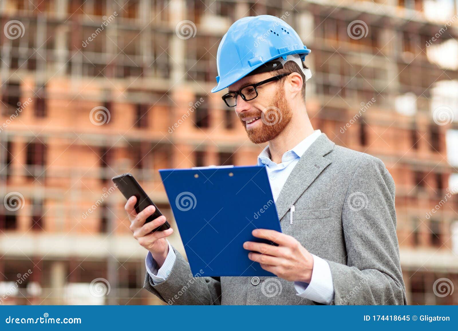 Young Architect or Engineer Inspecting Construction Site, Using Mobile ...