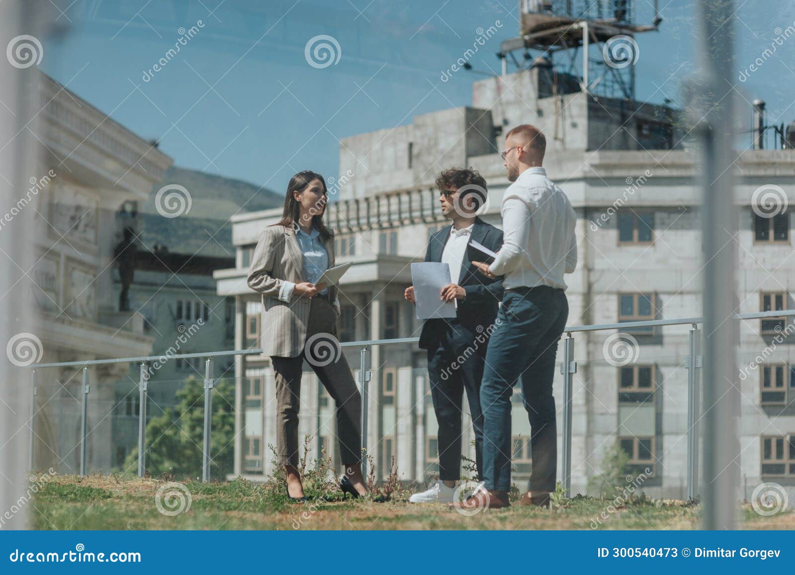 Young Architect Engineers Discussing Paperwork, Planning, Working ...