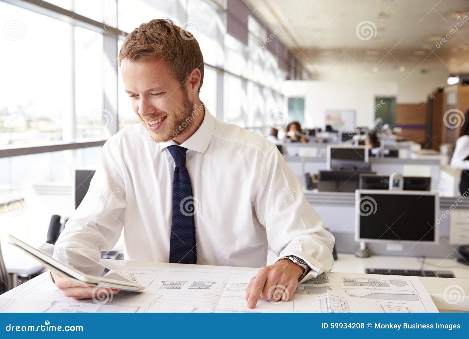 Young Architect at Work in an Office Using Tablet Computer Stock Photo ...