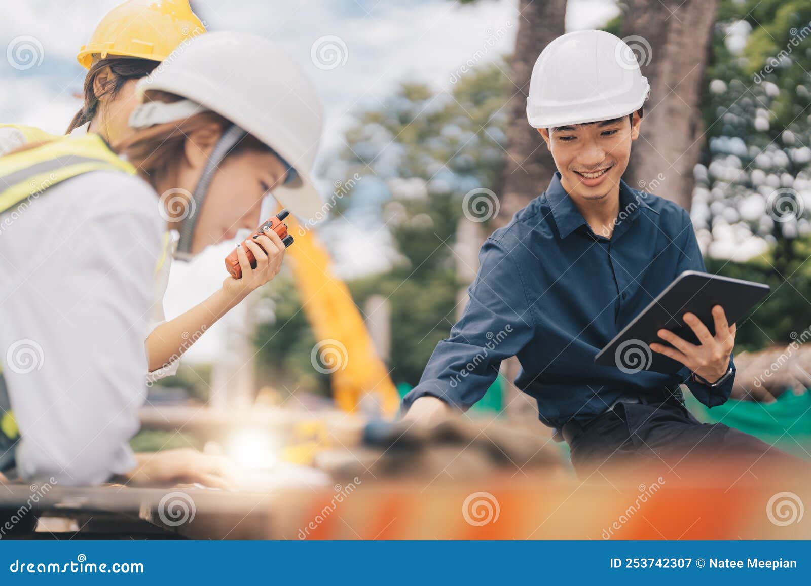 Young Asian Architects and Engineer Discussing Blueprints at ...