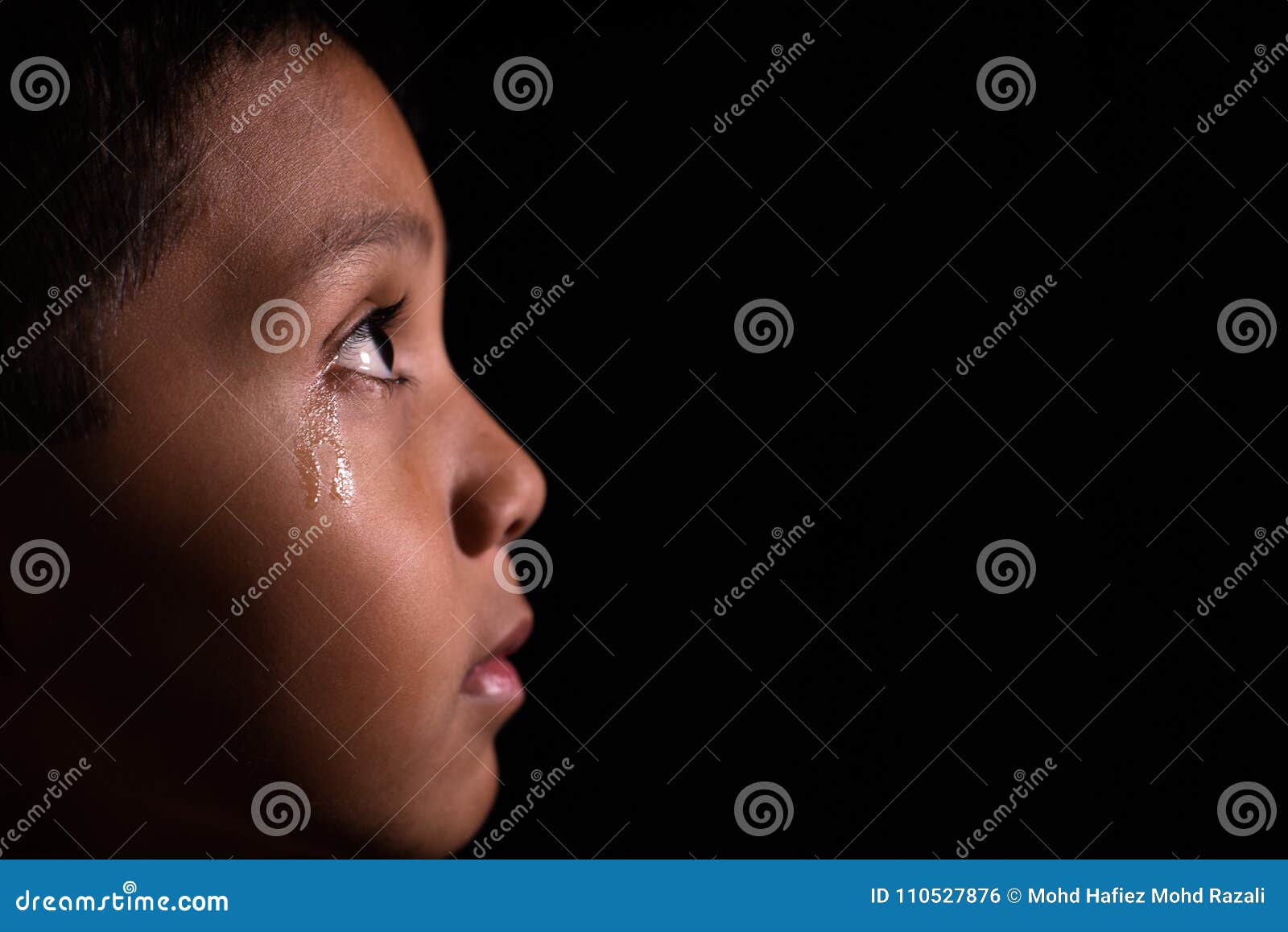 Young Asian Boy Looking into Light in Darkness with Tears in His Eye ...