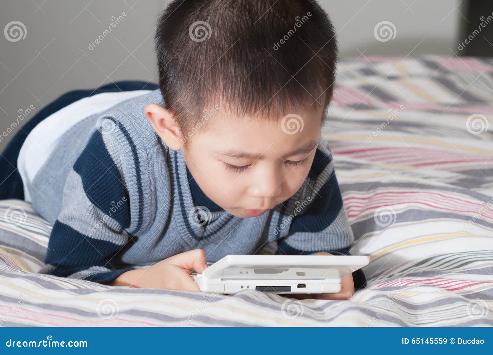 Young Asian Boy Playing Portable Console Game Stock Image - Image of ...