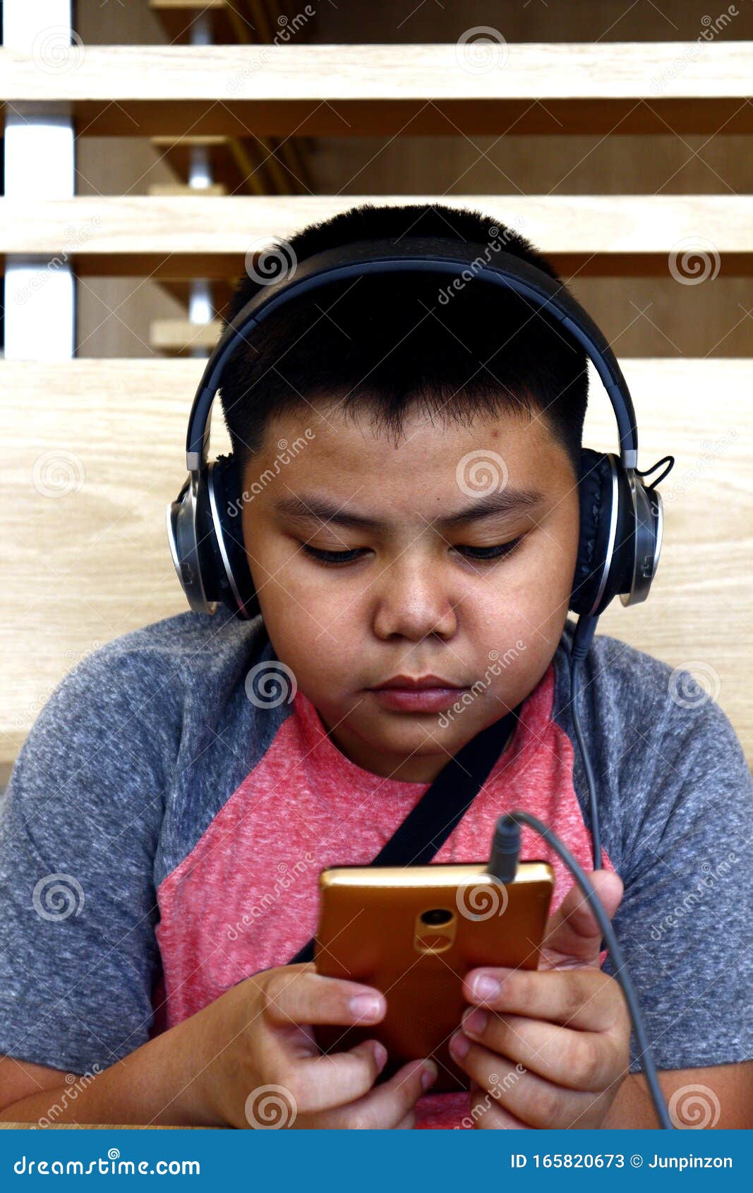 Young Asian Boy Using a Smartphone and Headphone Stock Image - Image of ...