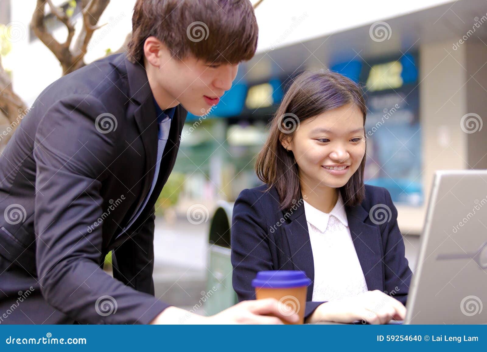 Young Asian Business Executives in Discussion Using Table PC Stock ...