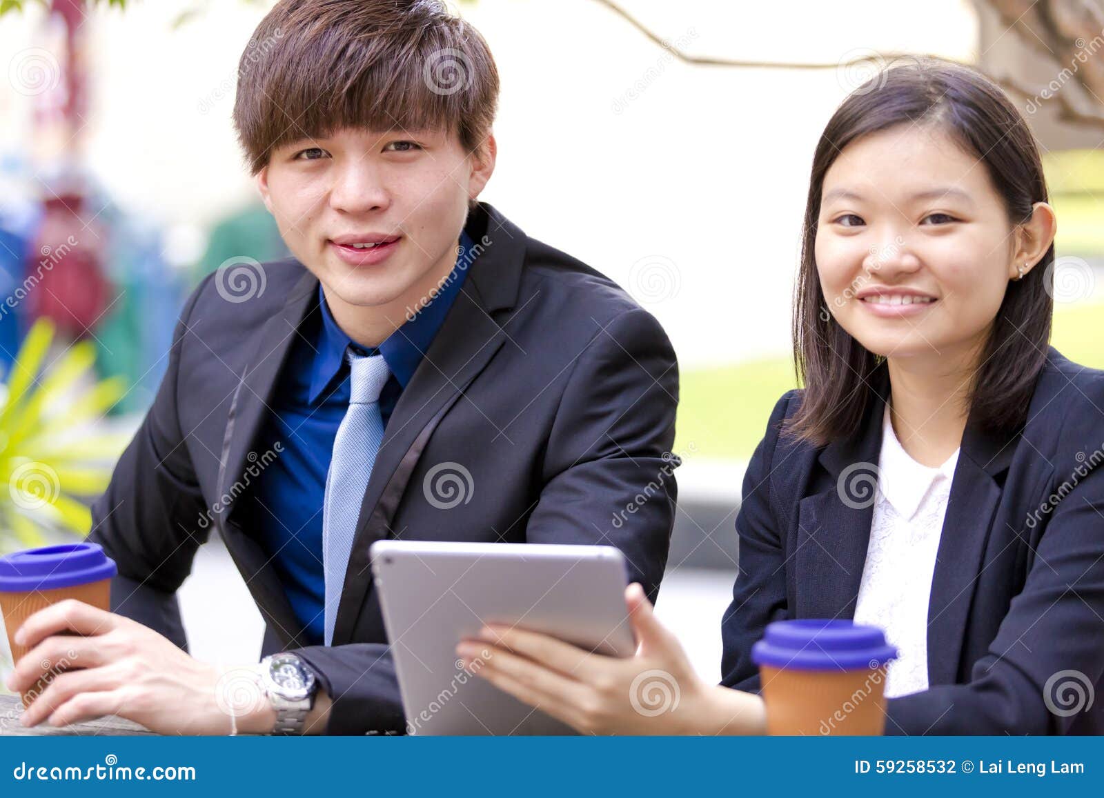 Young Asian Business Executives in Discussion Using Table PC Stock ...