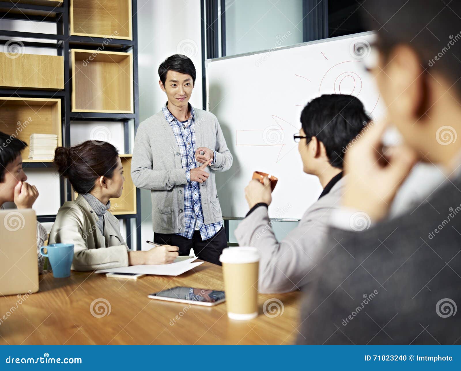 Young Asian Businessman Facilitating a Discussion Stock Photo - Image ...