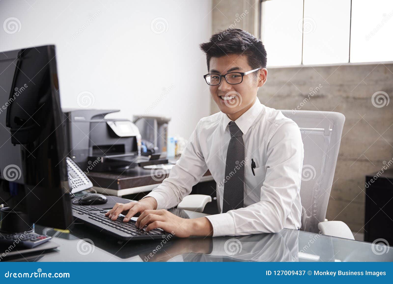 Young Asian Businessman Using a Computer, Smiling To Camera Stock Image ...