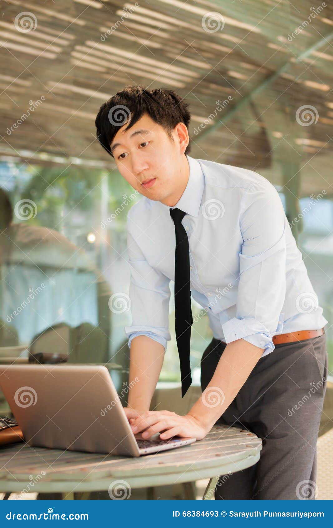 Young Asian Businessman Working on Computer while Standing in Outdoor ...