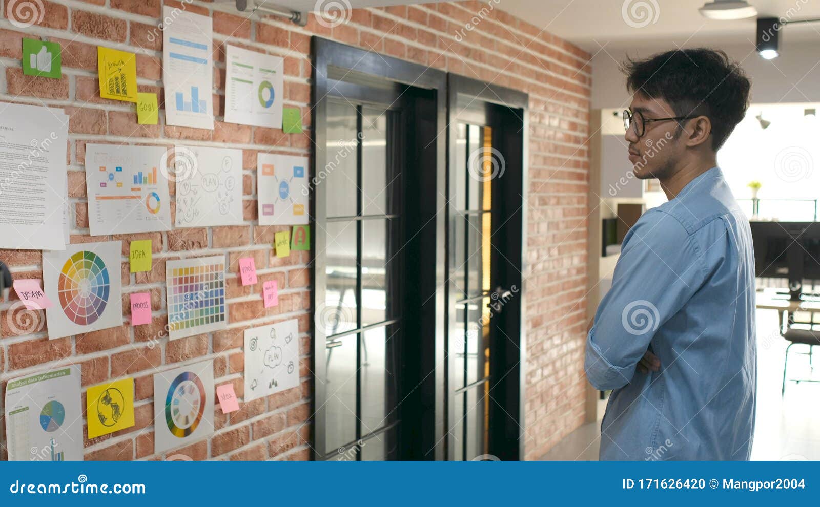 Young Asian Creative Design Man Reading and Thinking about Paper Work ...