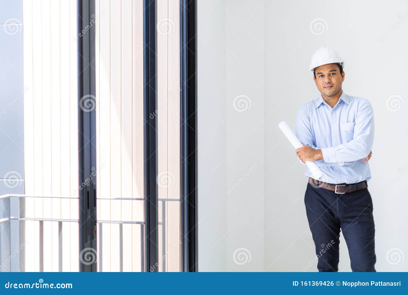 Young Asian Engineer or Architects Holding Layout Plan of Building ...