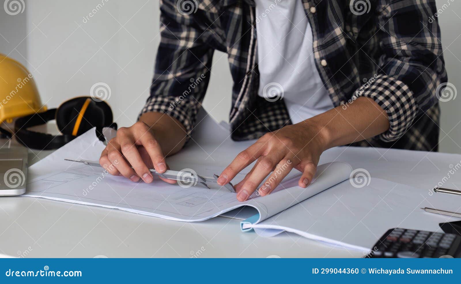 Young Asian Engineer Drawing Construction Project Plans on Plan Paper ...