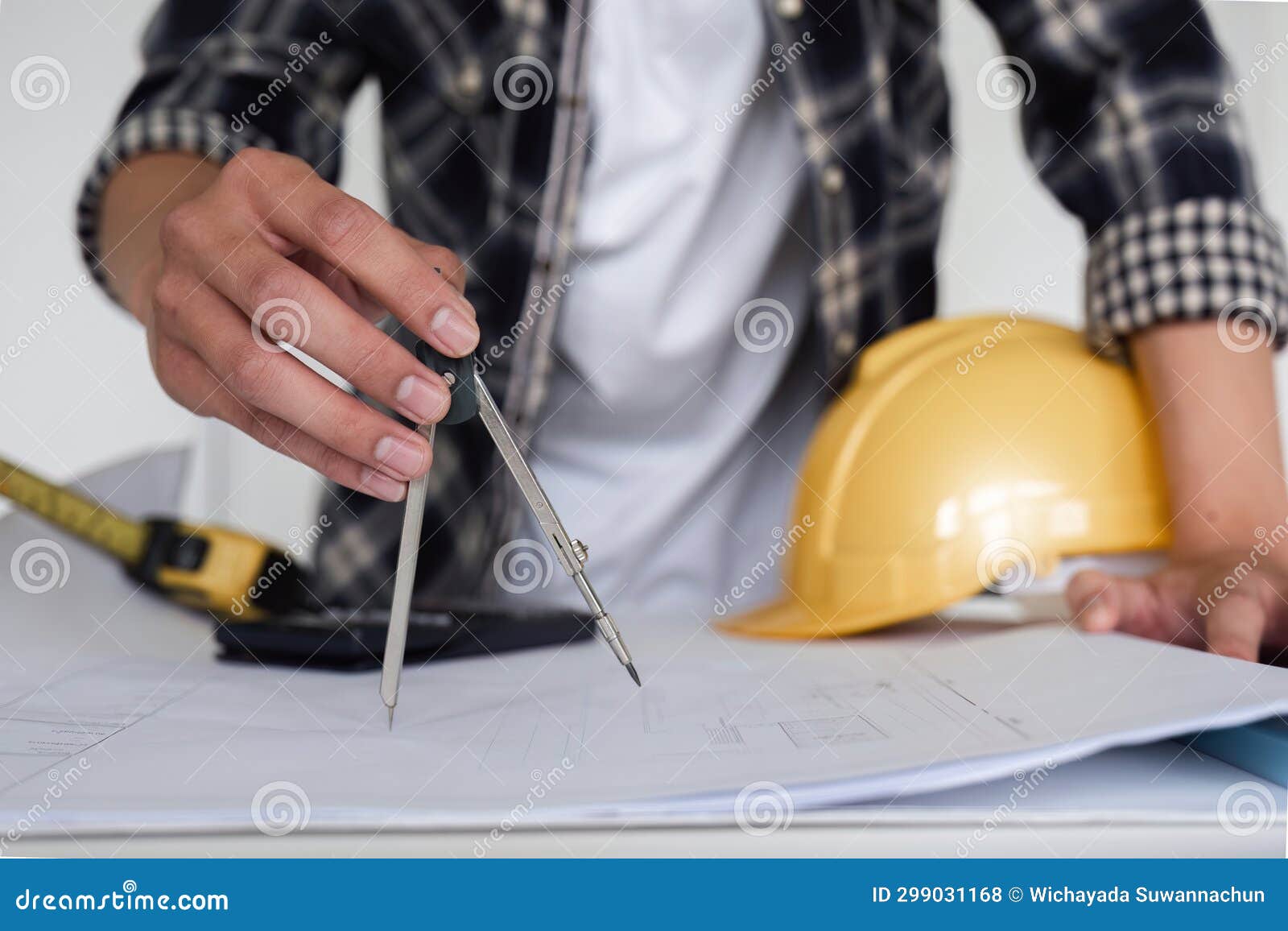 Young Asian Engineer Drawing Construction Project Plans on Plan Paper ...