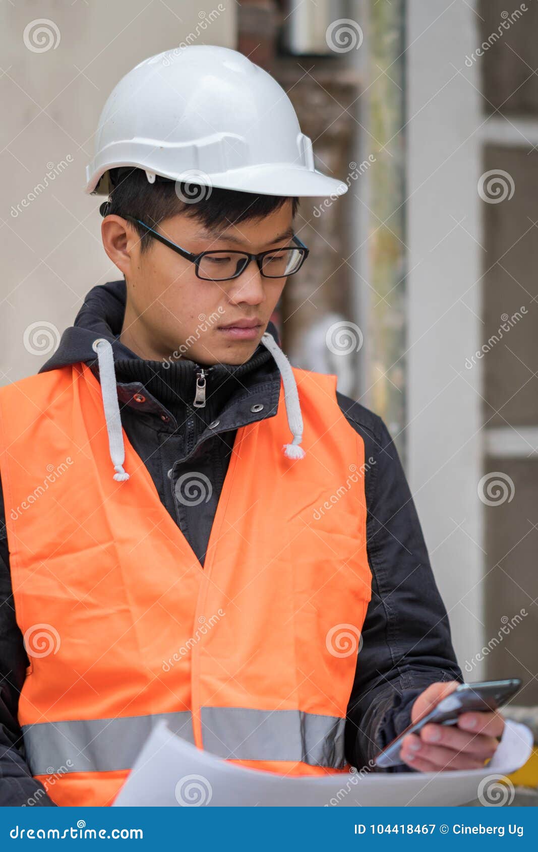 Young Asian Engineer Using His Smartphone on Construction Site Stock ...