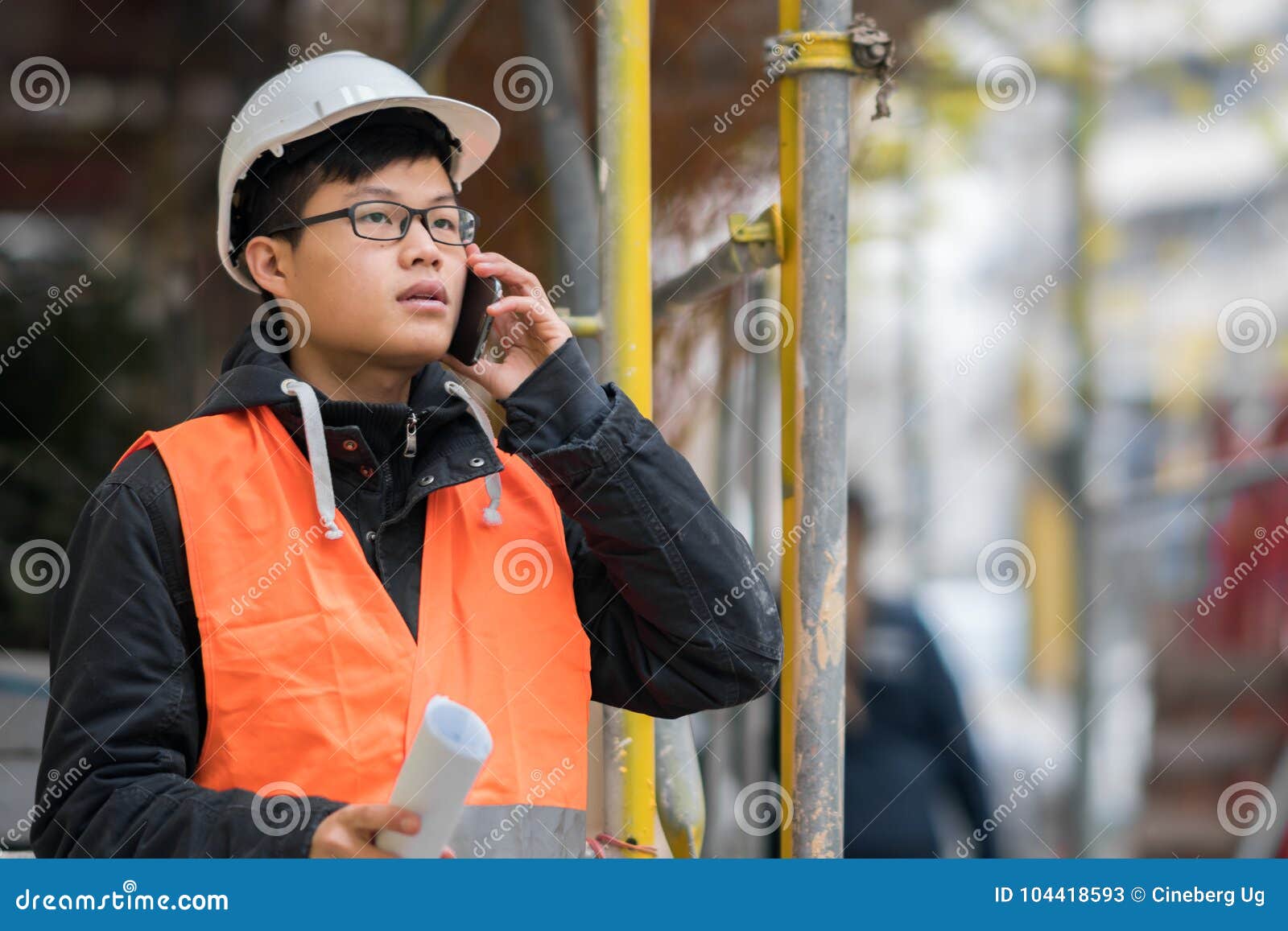 Young Asian Engineer Using His Smartphone on Construction Site Stock ...