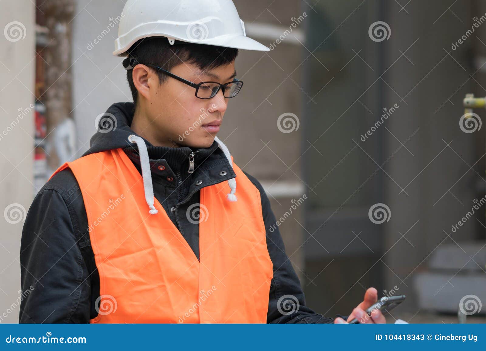 Young Asian Engineer Using His Smartphone on Construction Site Stock ...
