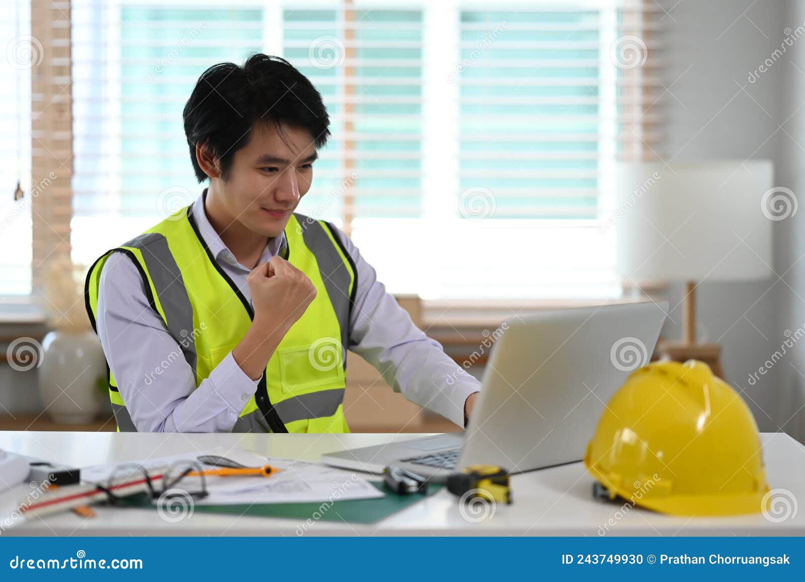 Young Engineer Worker in Reflective Jacket Looking at Laptop Computer ...