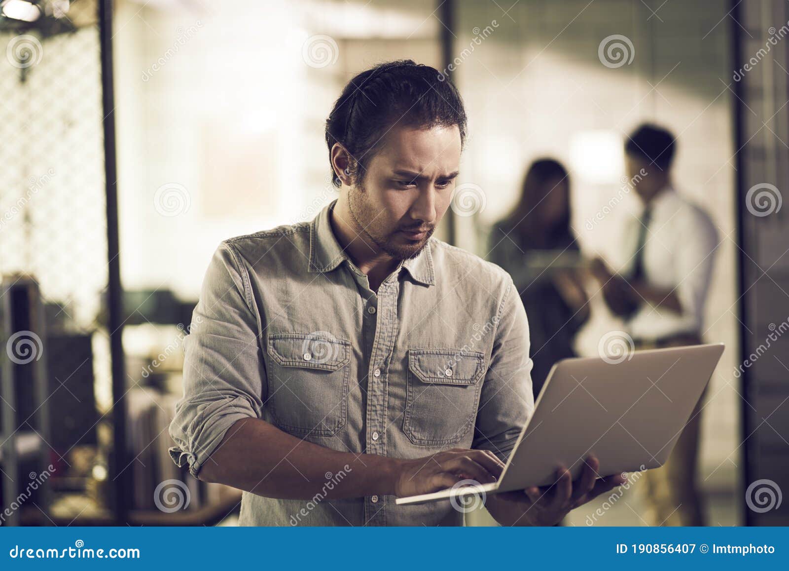 Young Asian Entrepreneur Using Laptop Computer in Office Stock Image ...