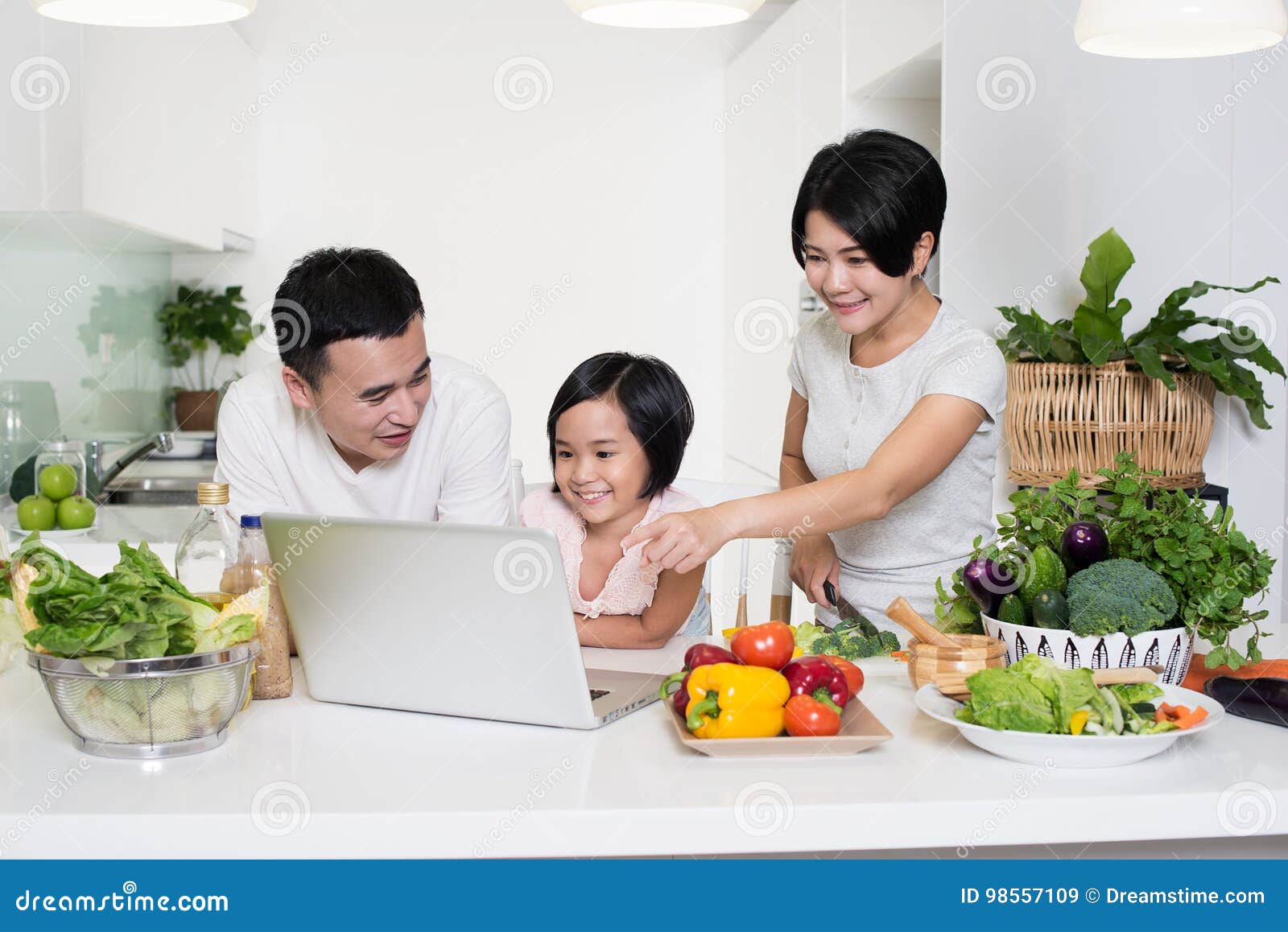 Young Asian Family Using the Computer Together at Home. Stock Image ...
