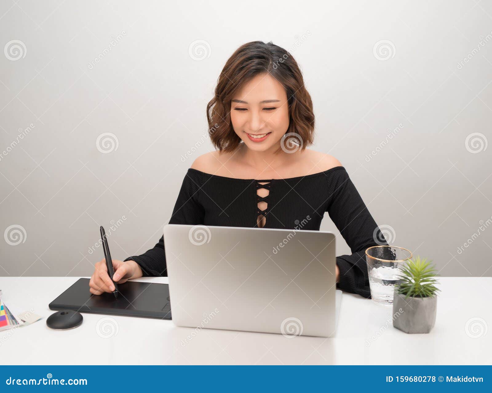 Young Asian Female Designer Using Graphics Tablet while Working with ...