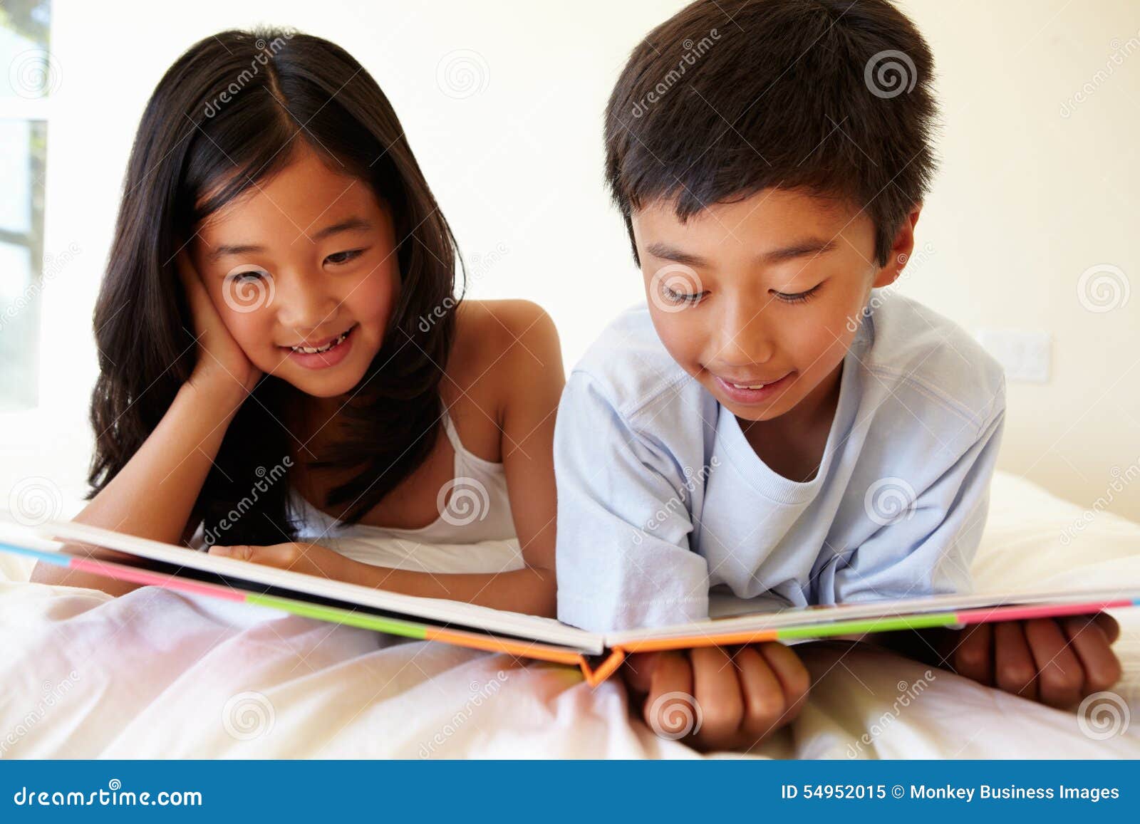 Young Asian Girl and Boy Reading Book Stock Image - Image of lifestyle ...