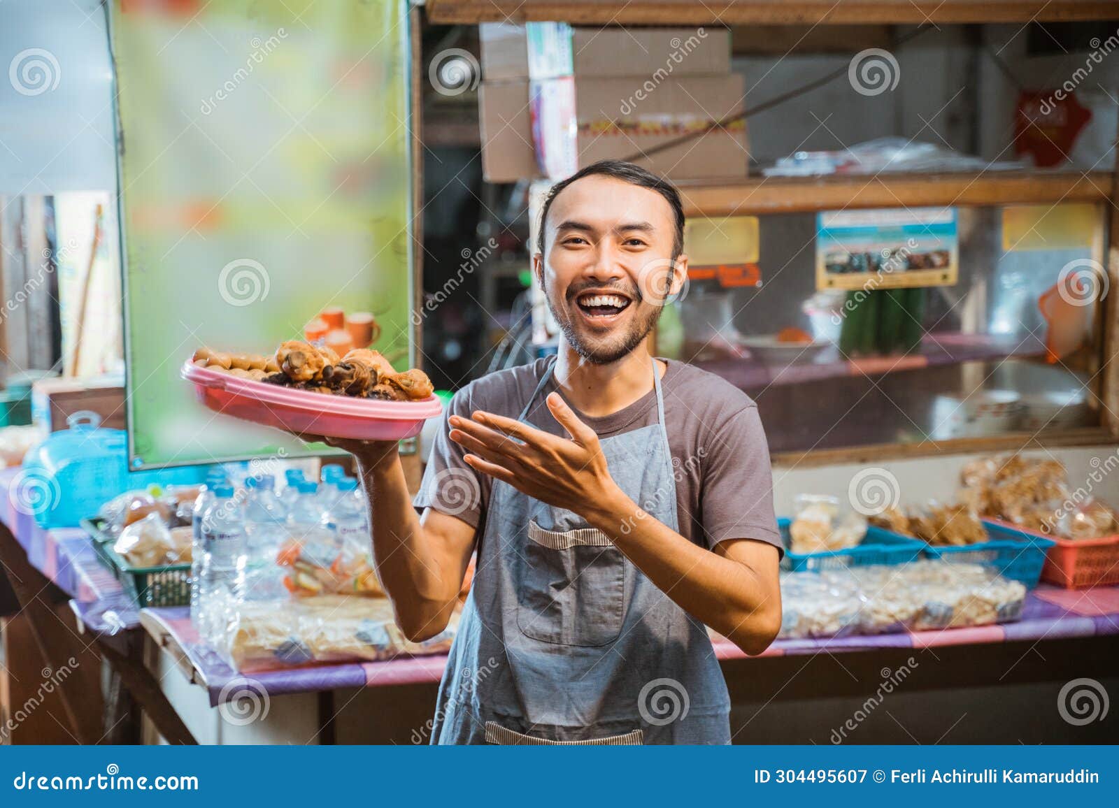 Young Asian Man Carrying of Snacks with an Offering Gesture Stock Image ...