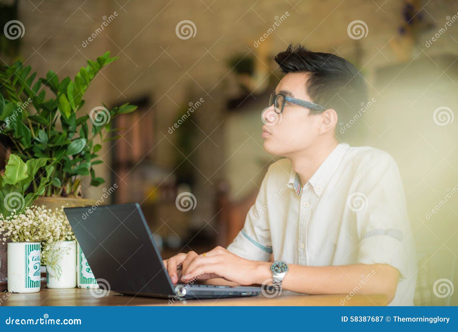 Young Asian Man Drinking Coffee in Cafe and Using Laptop Compute Stock ...