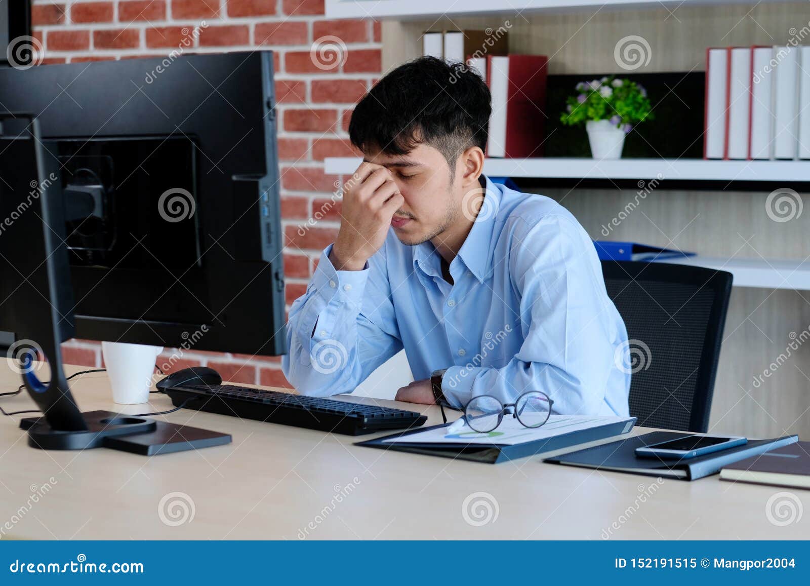 Young Asian Man with Frustrated Expression while Working with Computer ... Young Asian Man with Frustrated Expression while Working with Computer ...