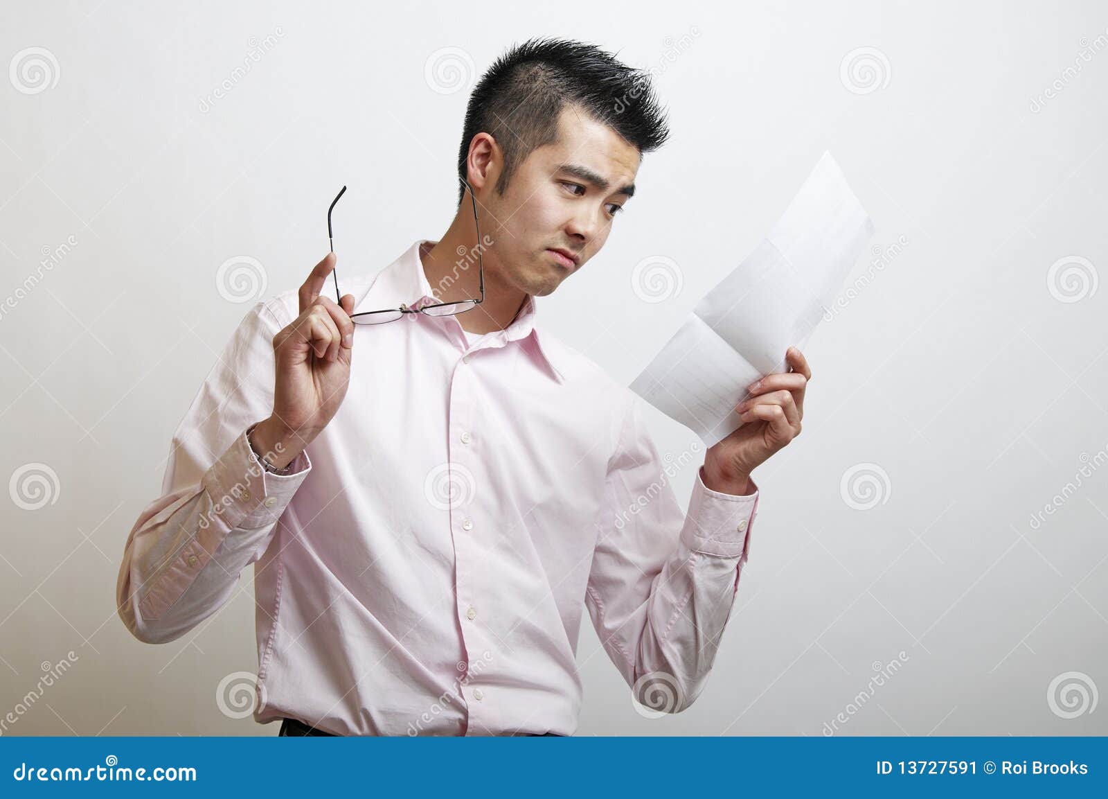 A Young Asian Man Reading a Letter Stock Image - Image of office ...