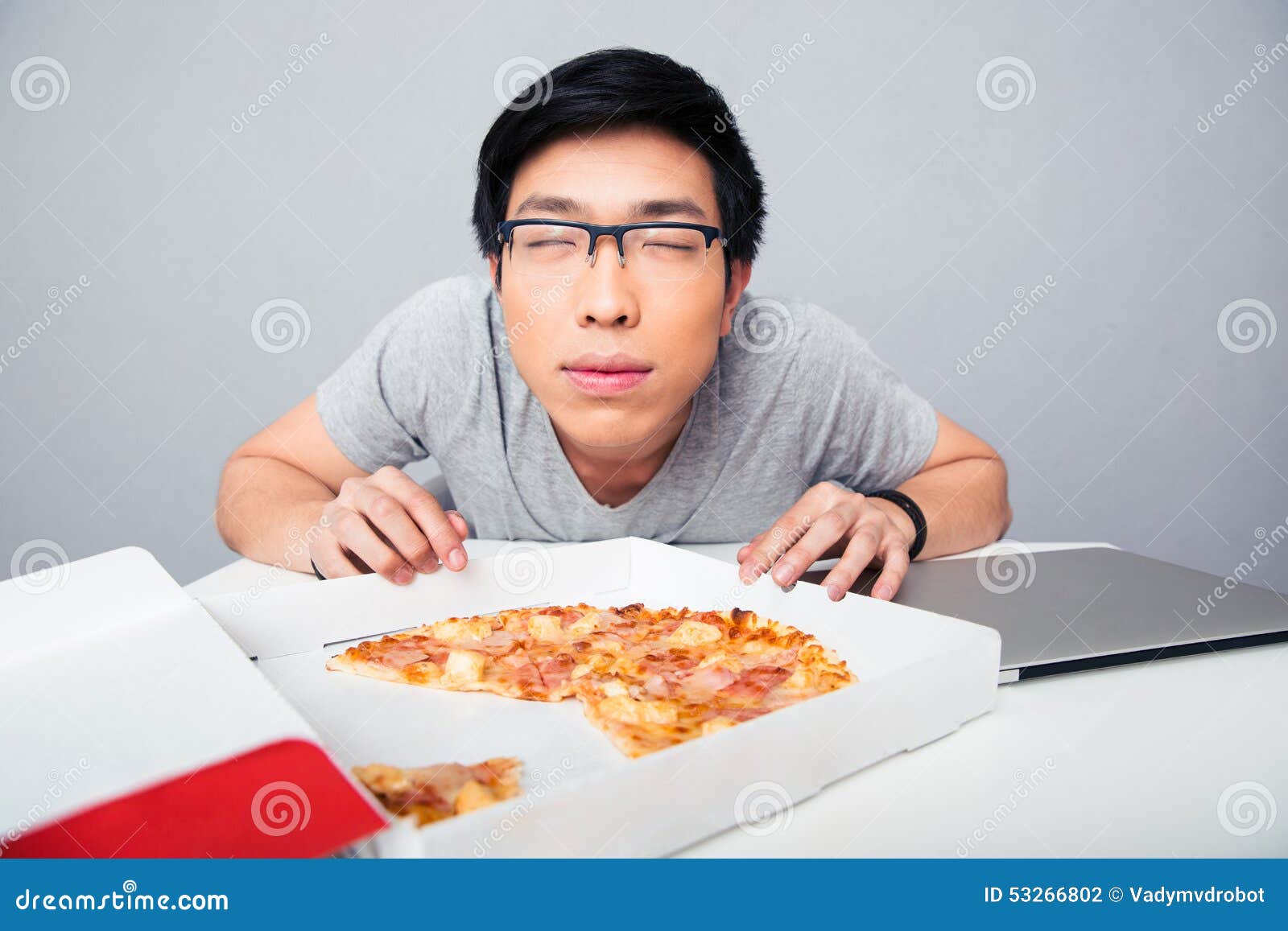 Young Asian Man Smelling Pizza Stock Photo - Image of businessman, gray ...
