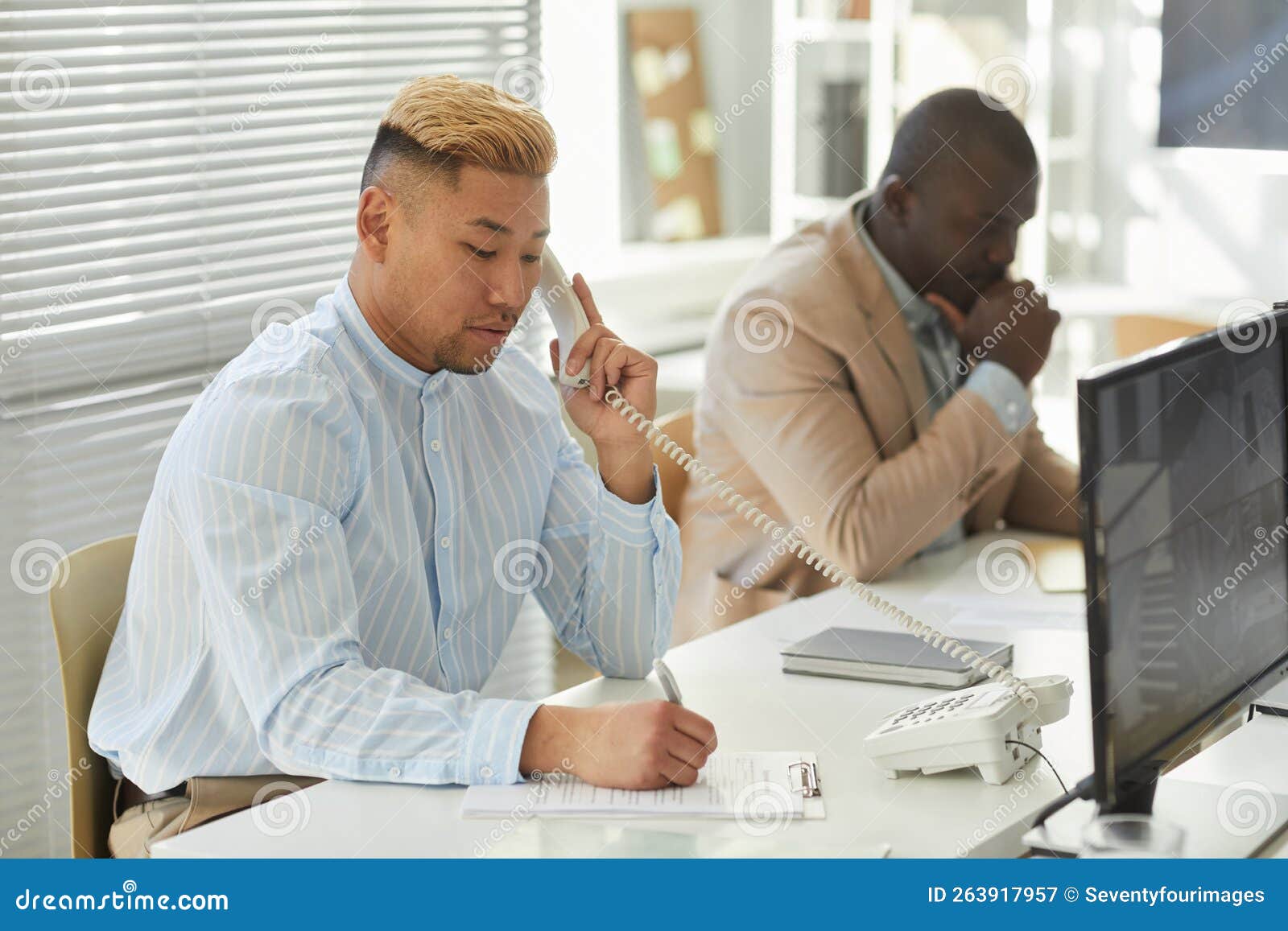 Young Asian Man Speaking by Phone in Customer Support Center Stock ...