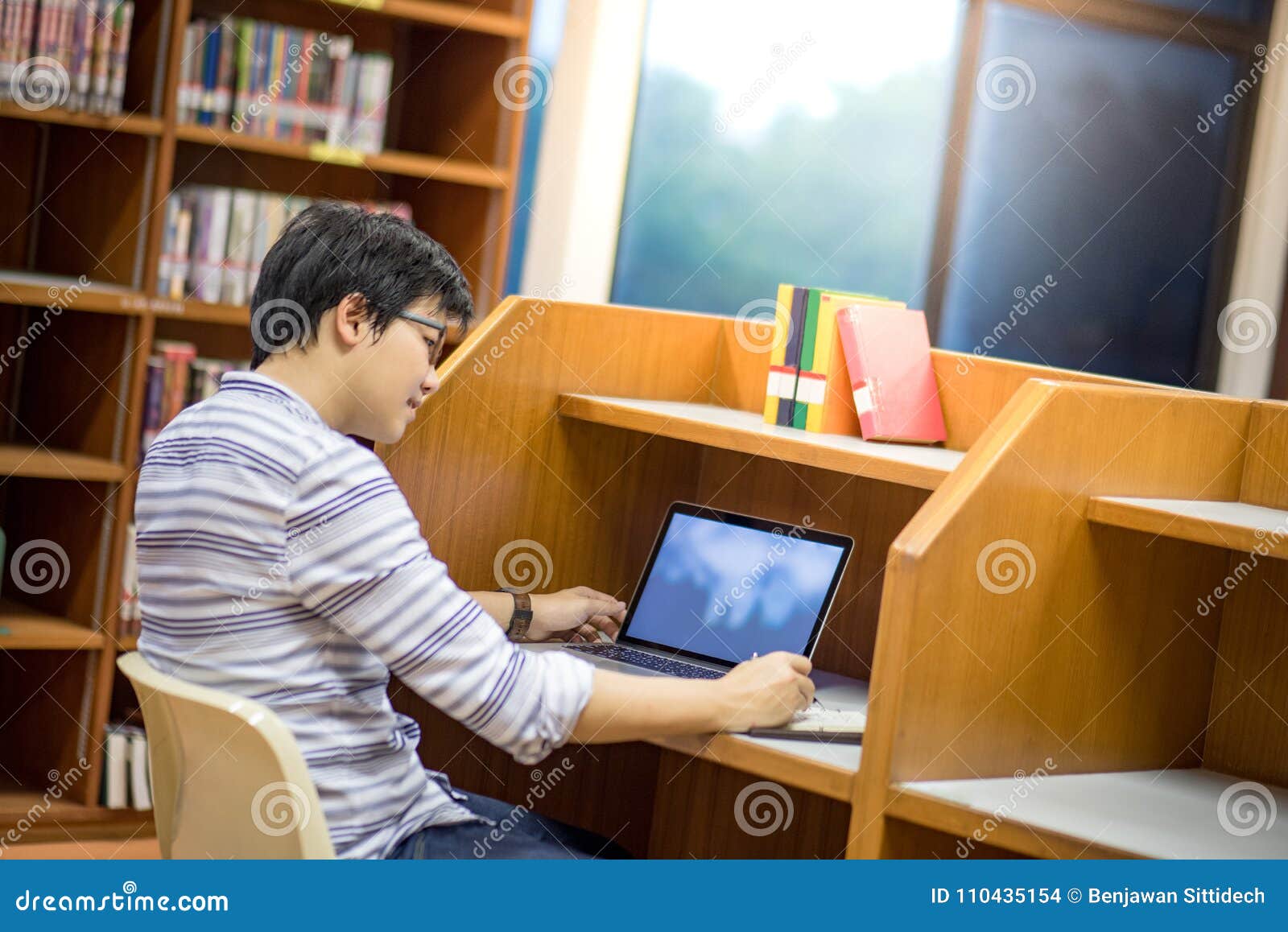 Young Asian University Student Using Laptop in Library Stock Photo ...
