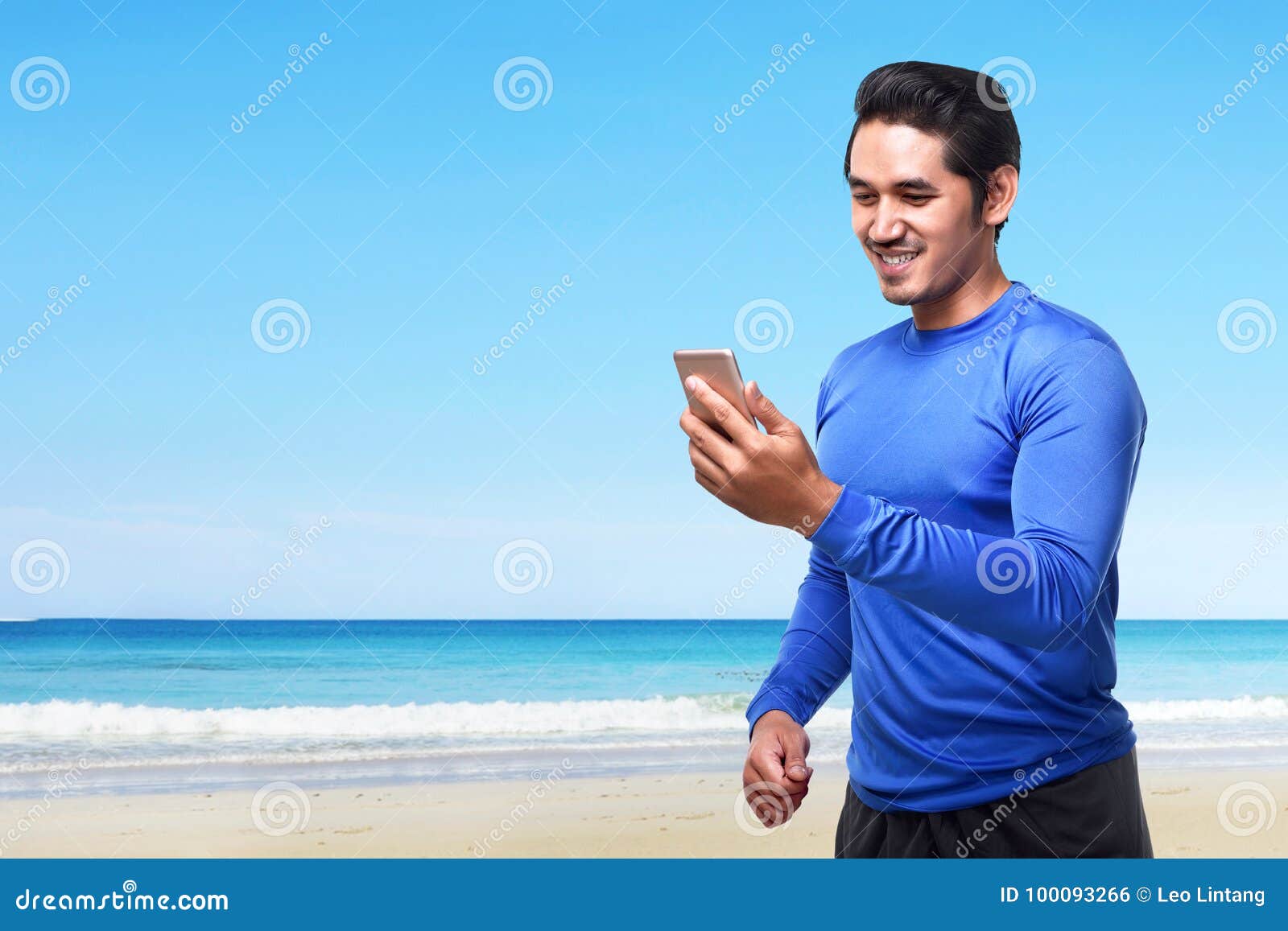Young Asian Man Using Mobile Phone before Going for a Run Stock Photo ...