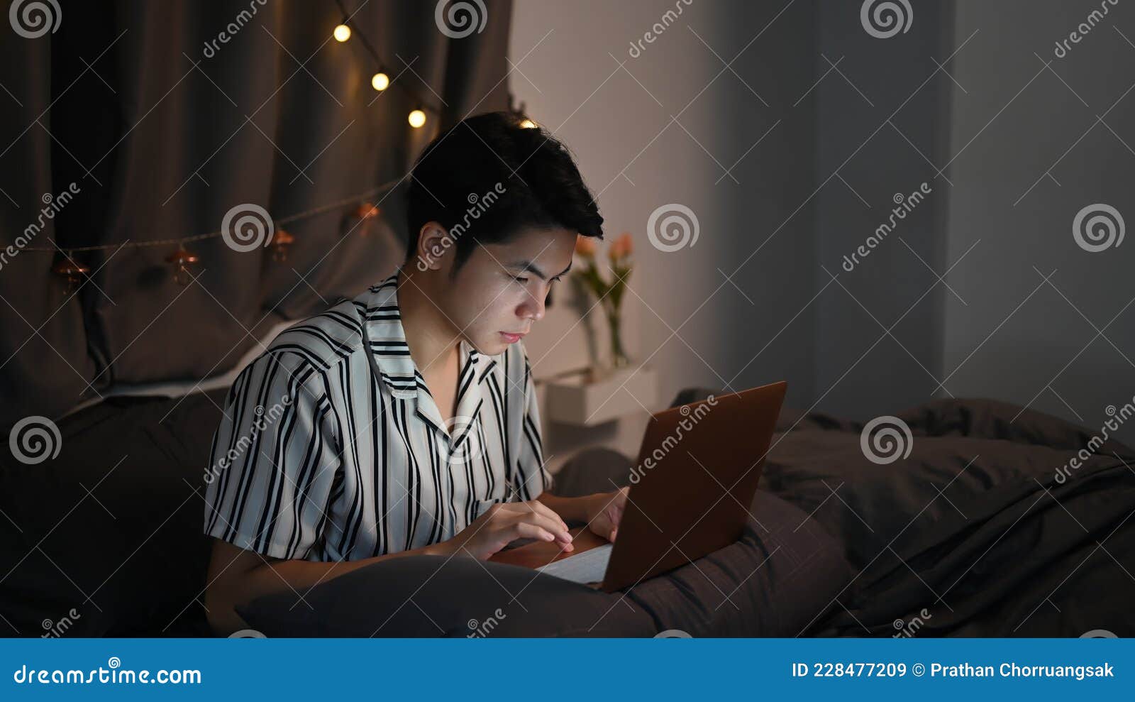 Young Man Working with Computer Laptop on His Bed at Late Night. Stock ...