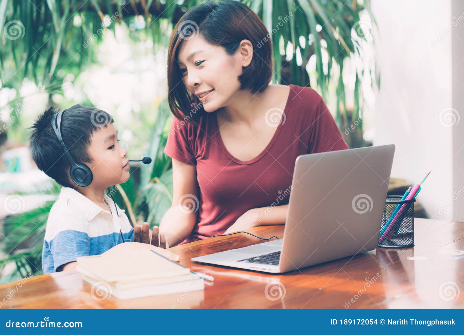 Young Asian Mother and Son Using Laptop Computer for Study and Learning Together at Home. Stock ...