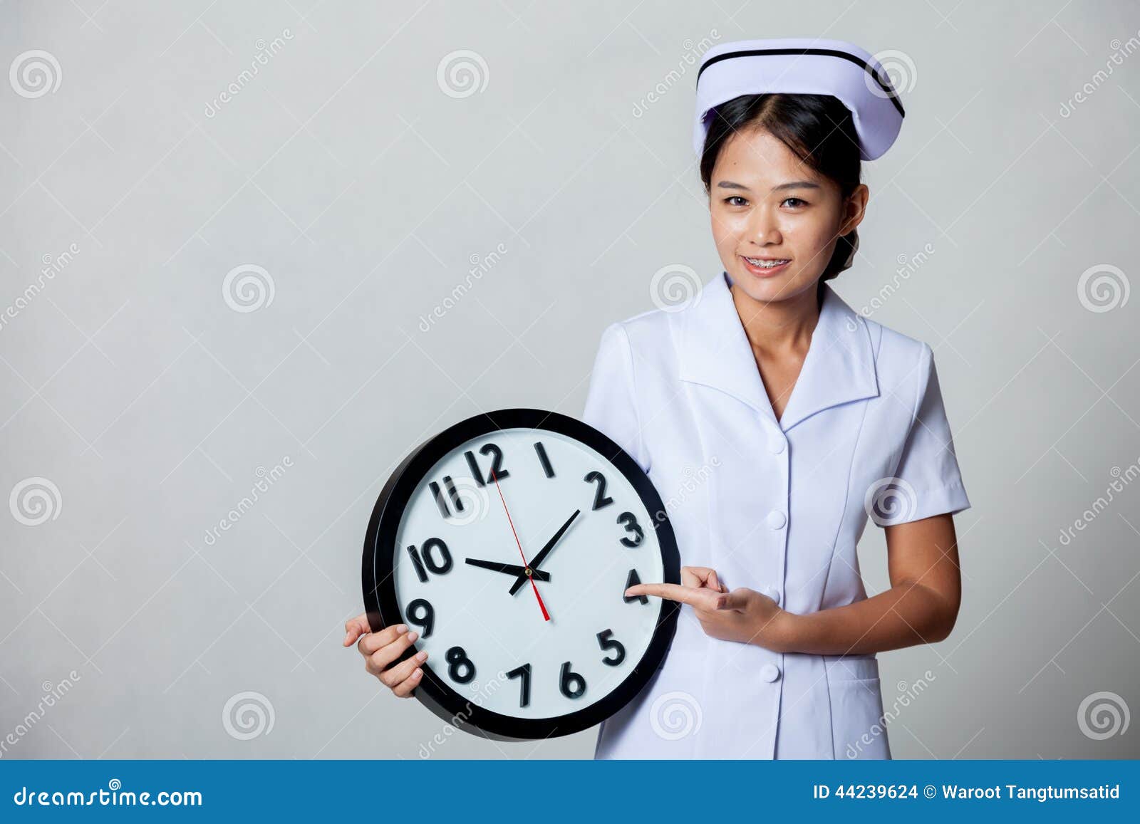 Young Asian Nurse Point To a Clock Stock Photo - Image of portrait ...