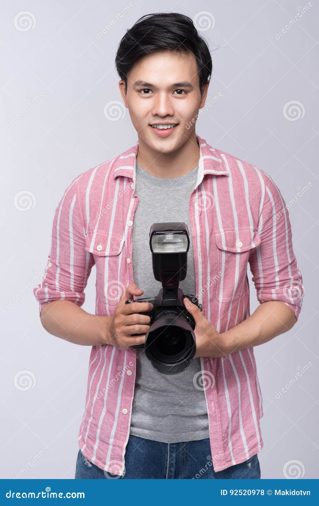 Young Asian Photographer Holding Digital Camera, while Working I Stock ...