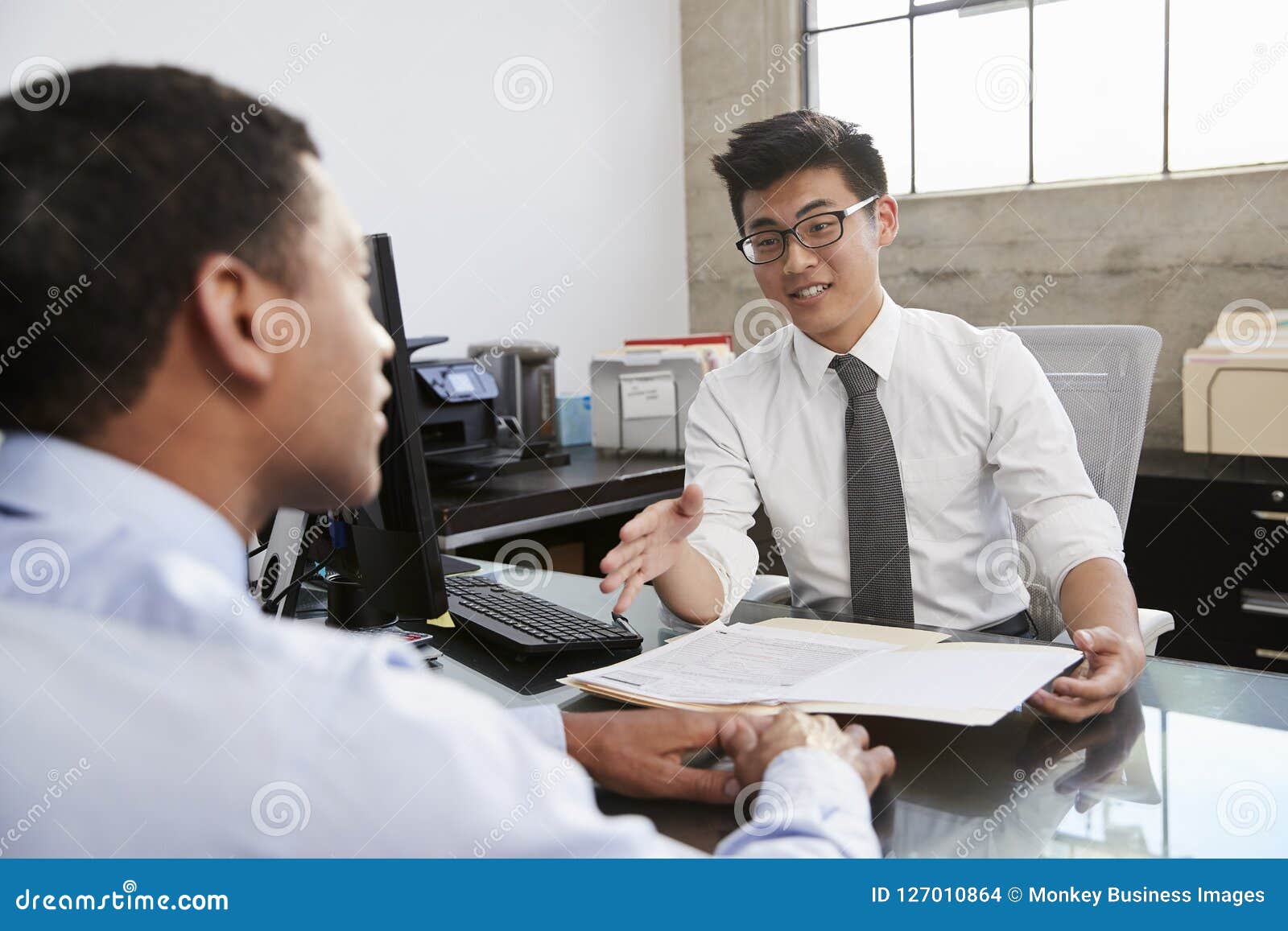 Young Asian Professional in Meeting with Mixed Race Man Stock Photo ...