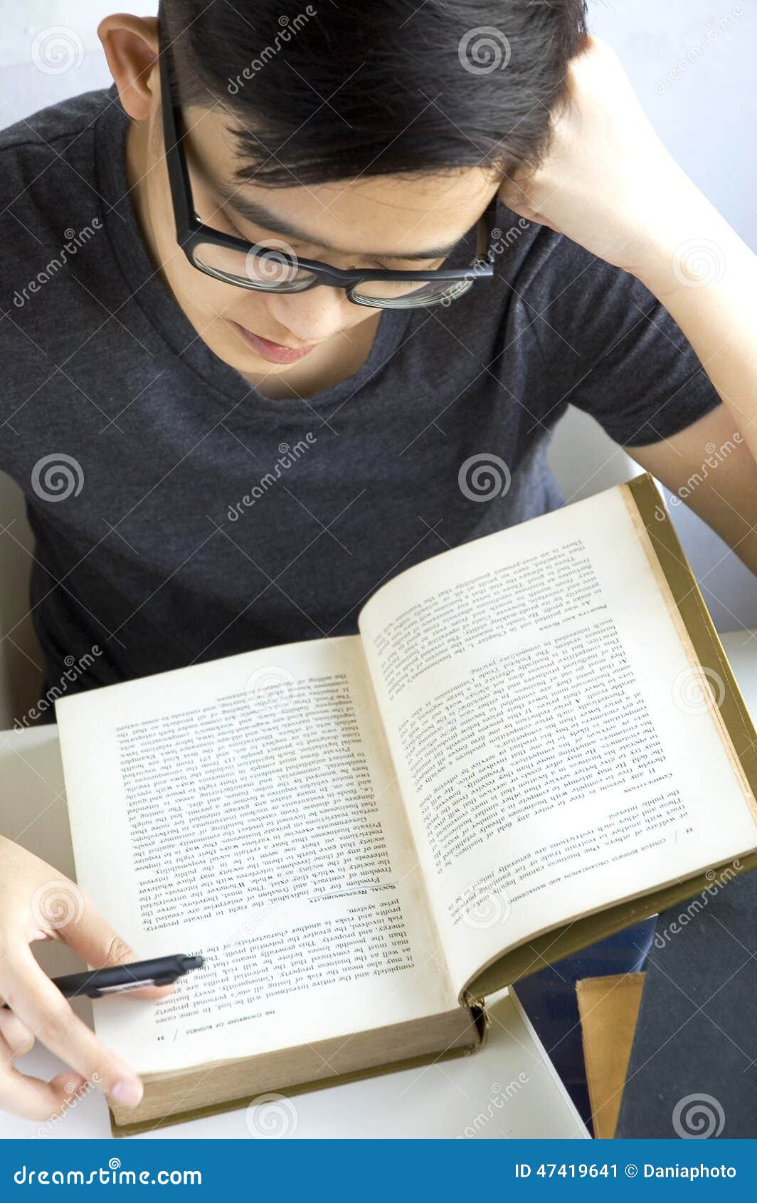 Young asian reading text stock image. Image of books - 47419641