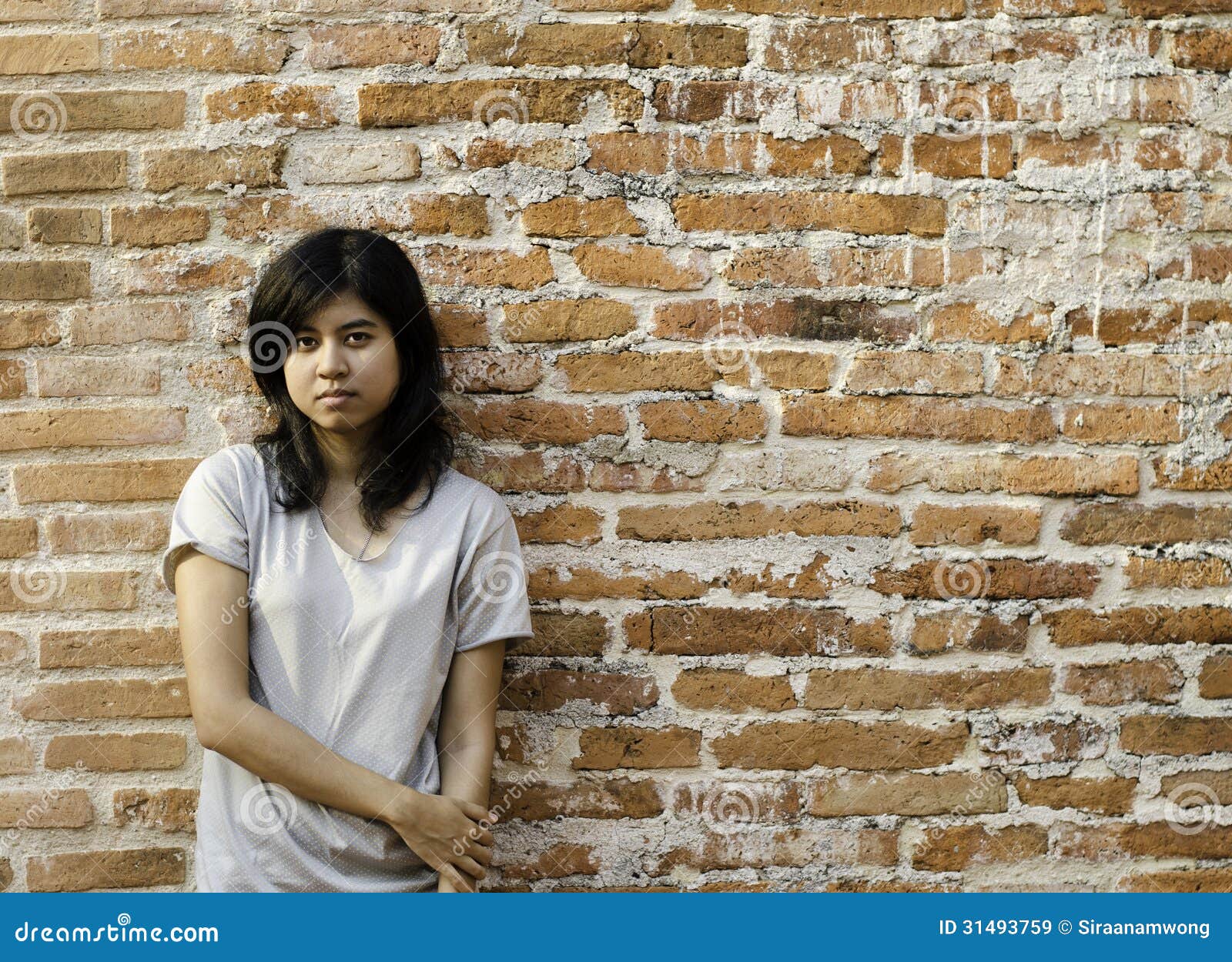 Young Asian Woman Against a Brick Wall Stock Image - Image of copy ...