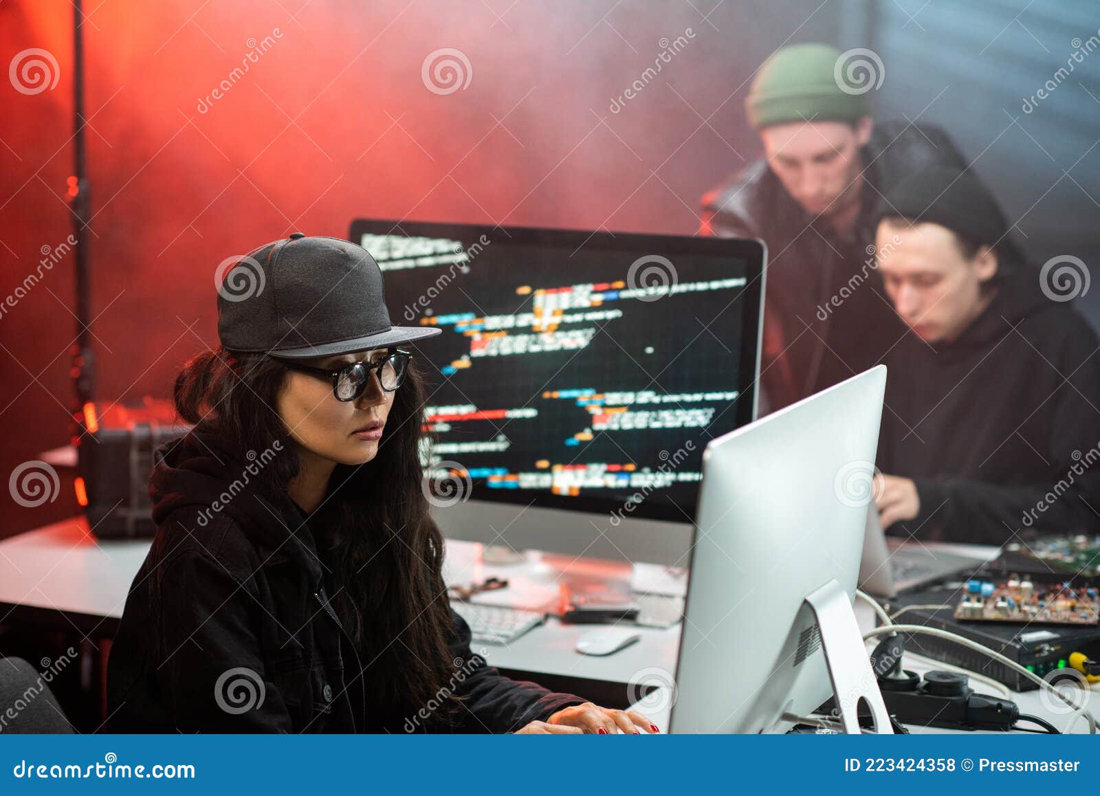 Young Asian Woman in Hacker Attire Decoding Information Stock Photo ...