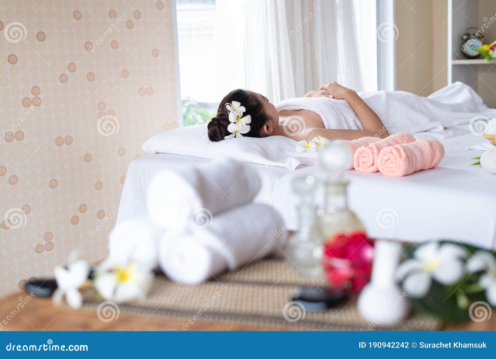 Beautiful Asian Woman Lying Down On Massage Bed Relaxing In Spa Salon